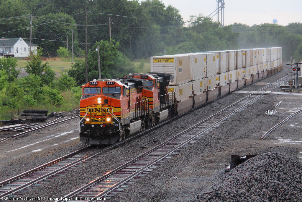 BNSF 4445 leads a eb stack train in a down pour.